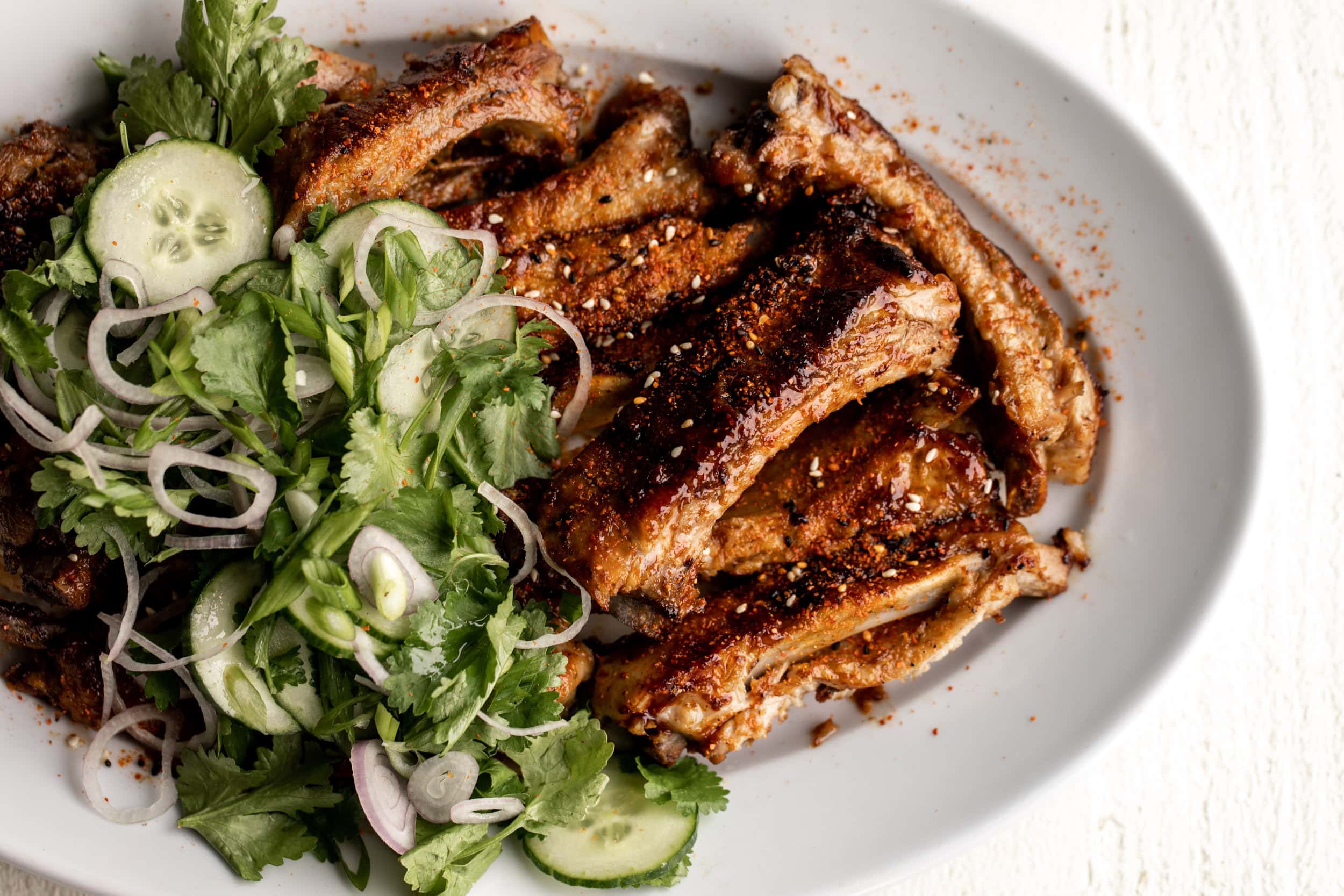 Togarashi Pork Ribs with Cucumber Herb Salad